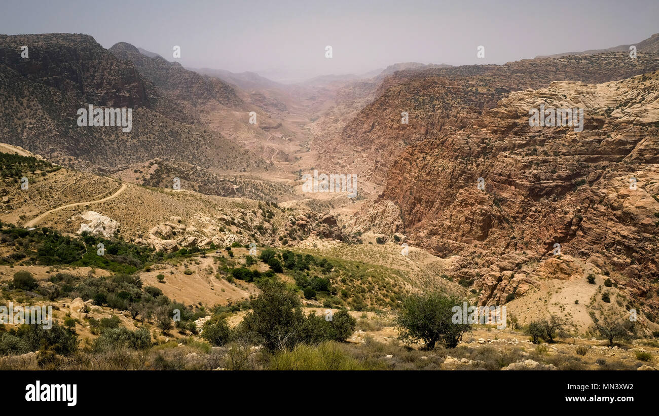Wadi Dana valley in an arid climate landscape and mist Stock Photo - Alamy