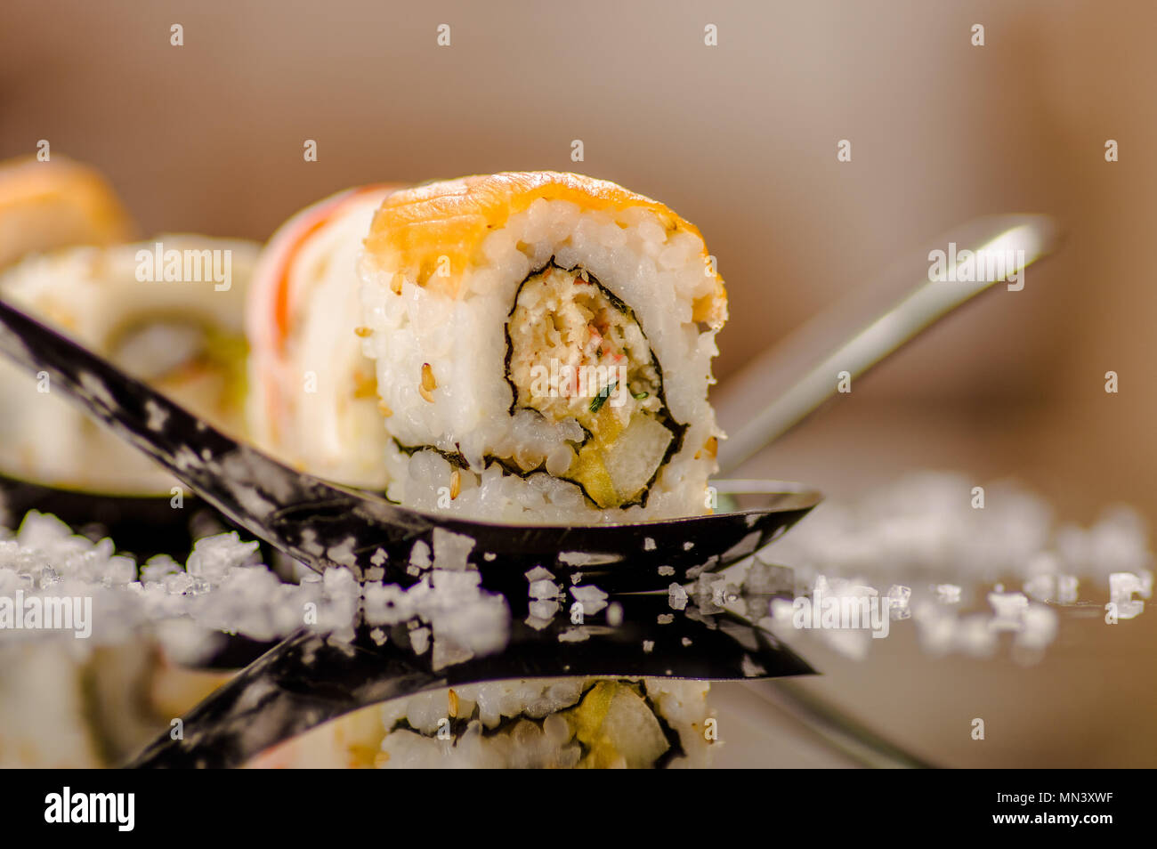 Close up of selective focus of delicious sushi rolls over a metallic ...