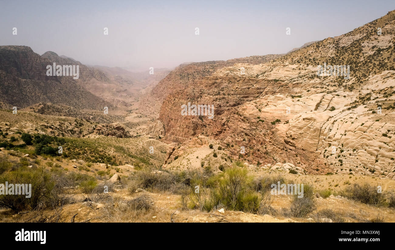 Wadi Dana valley in an arid climate landscape and mist Stock Photo - Alamy