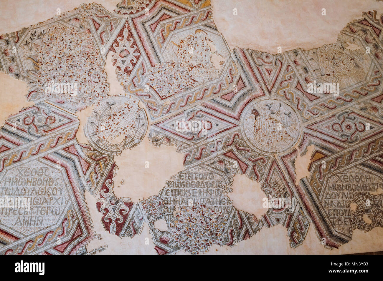 Ancient mosaic pattern with scripture in Madaba Archaeological Park ...