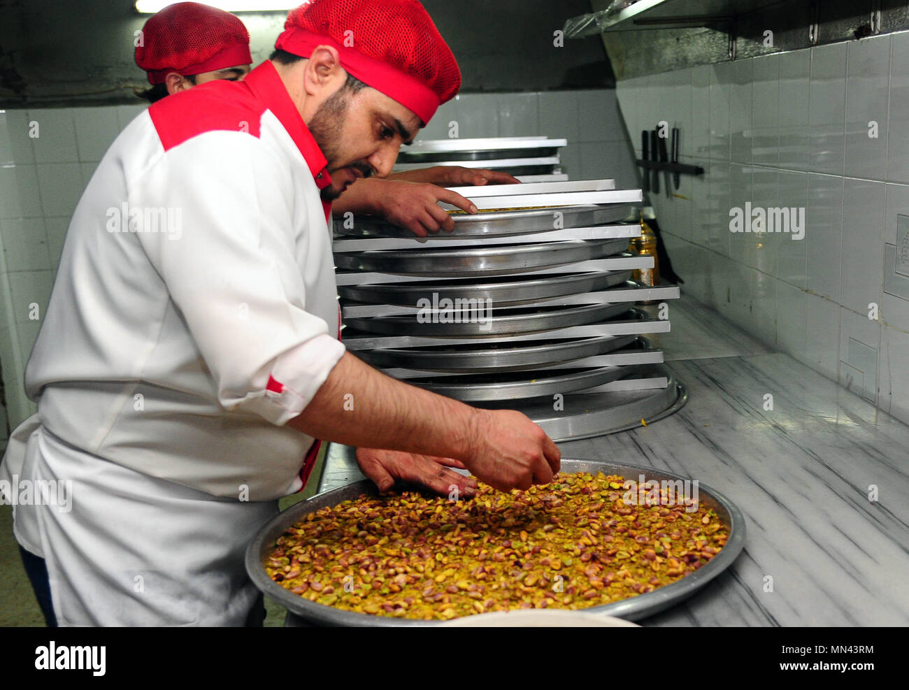 Damascus, Damascus. 13th May, 2018. A Syrian dessert maker makes Haresa ...