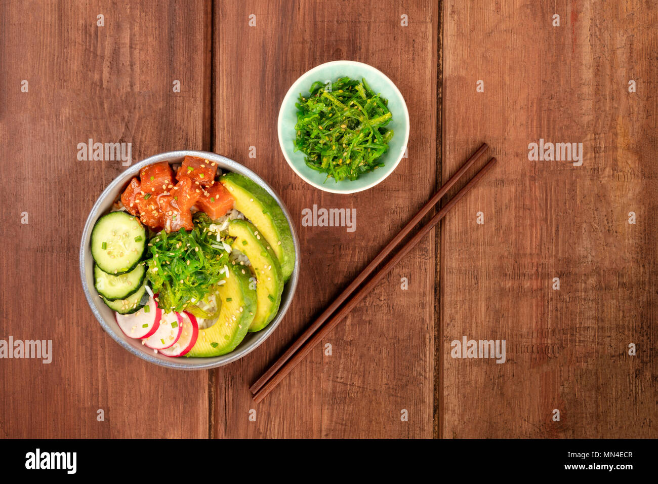 An overhead photo of poke, traditional Hawaiian raw fish salad, with a ...