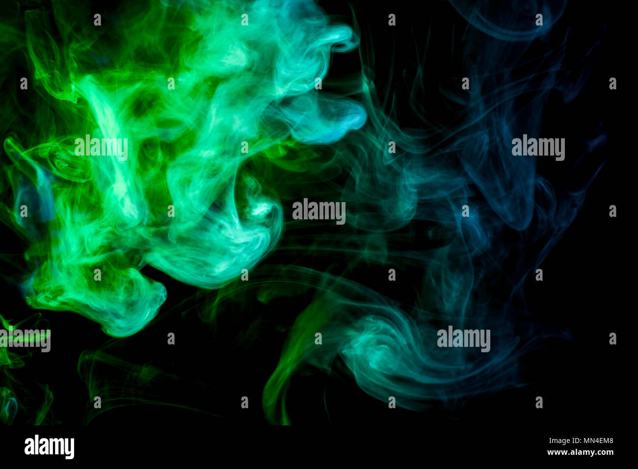 Thick green colorful smoke on a black isolated background. Background ...