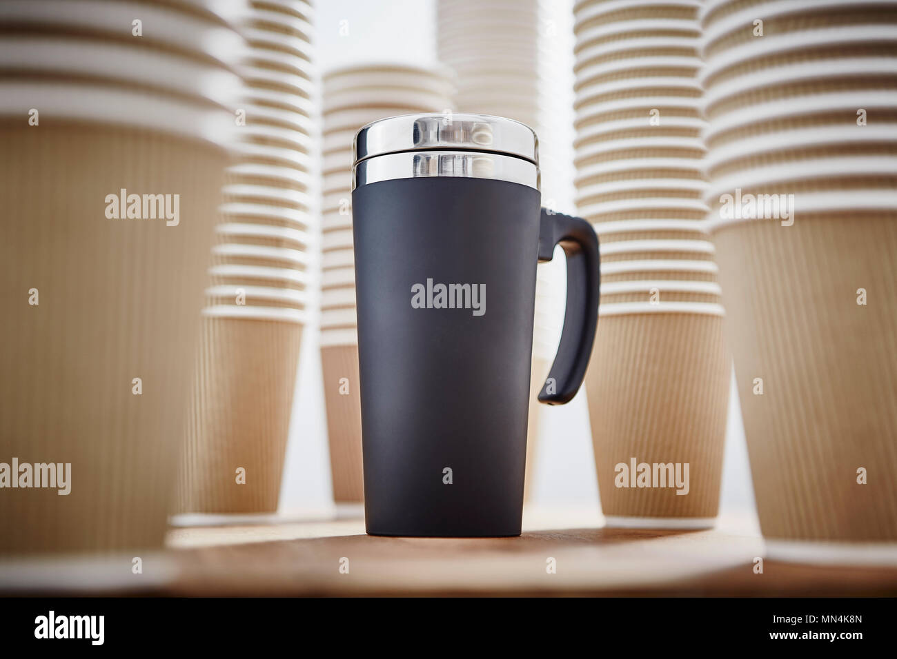 Insulated drink container surrounded by disposable coffee cups Stock ...