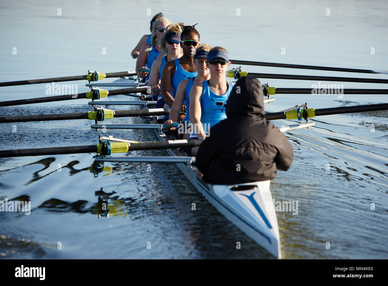 Female rowers rowing scull on lake Stock Photo - Alamy