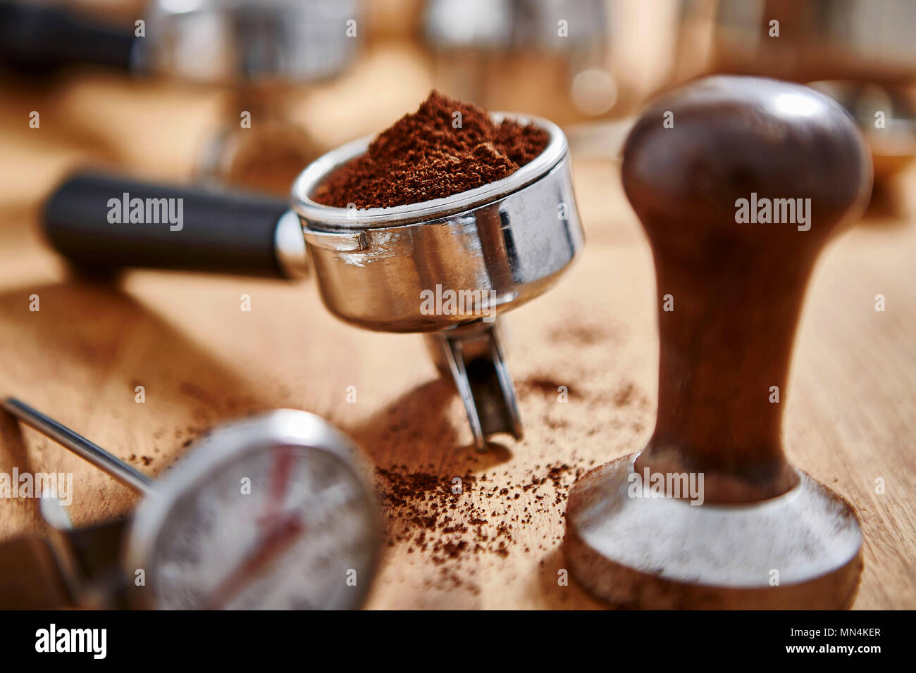Espresso grounds and coffee tamper Stock Photo - Alamy