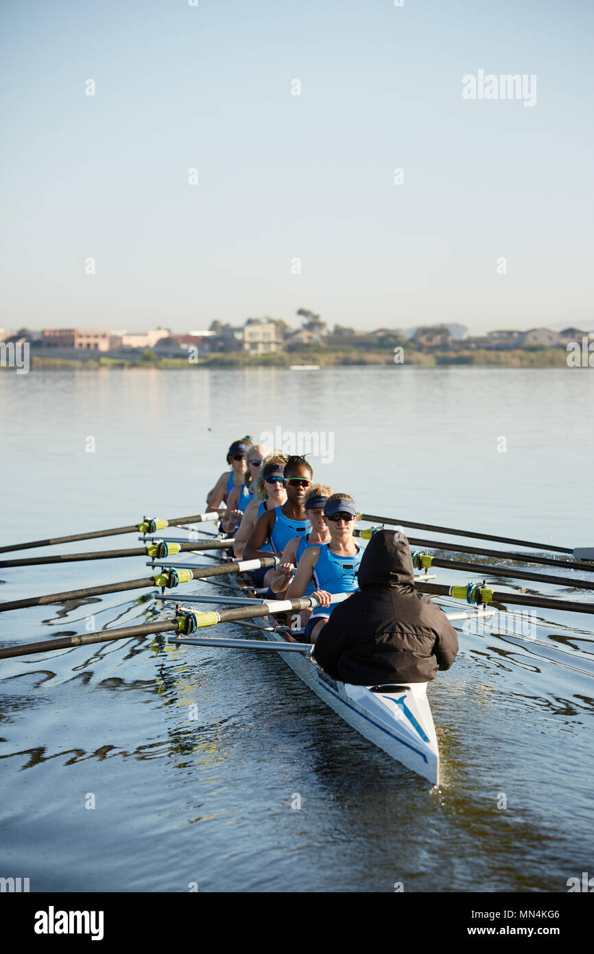Female rowers rowing scull on sunny lake Stock Photo - Alamy