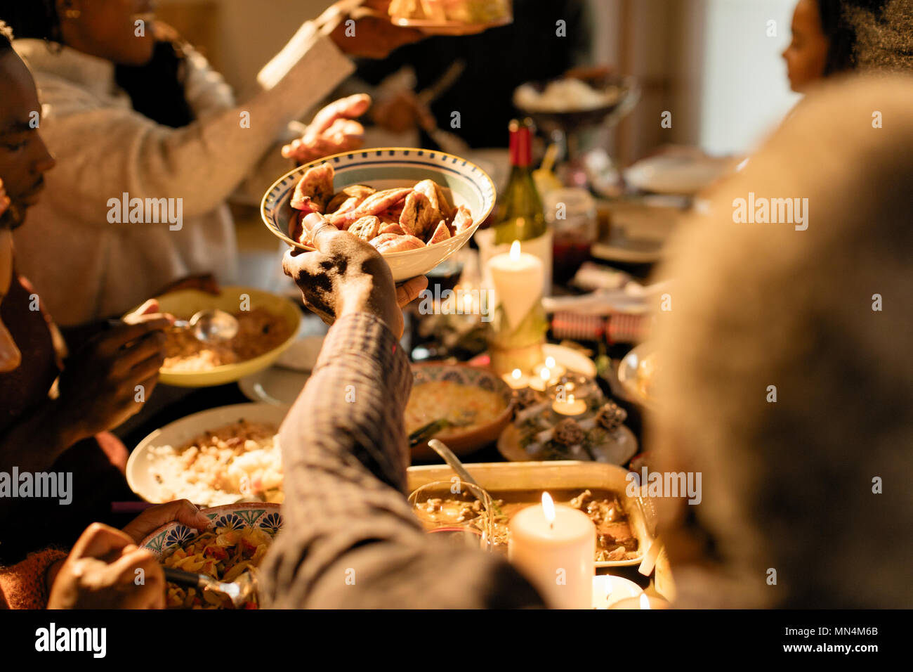 Family passing food at Christmas dinner Stock Photo - Alamy