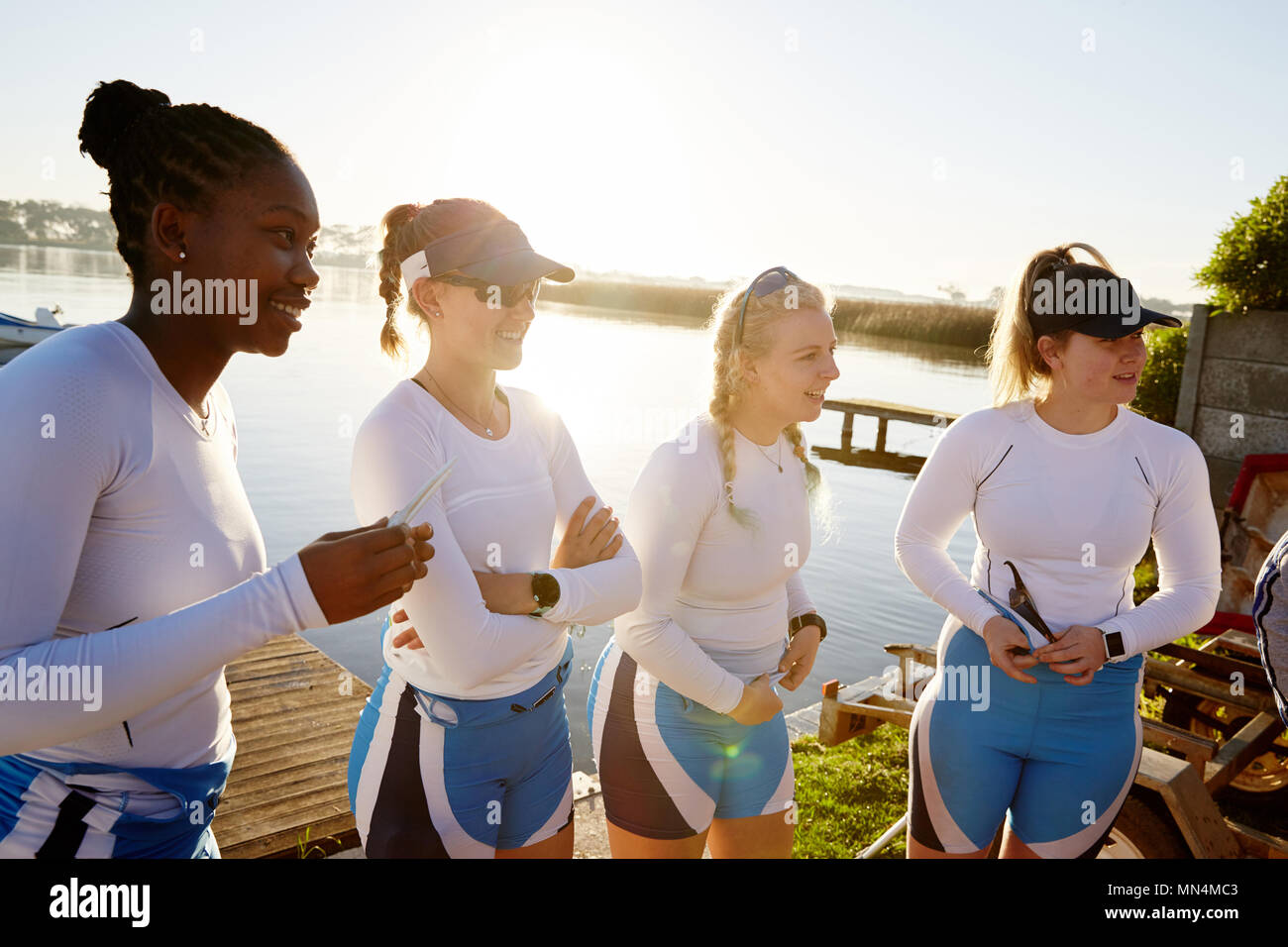 Female rowing team standing at sunny lakeside Stock Photo - Alamy