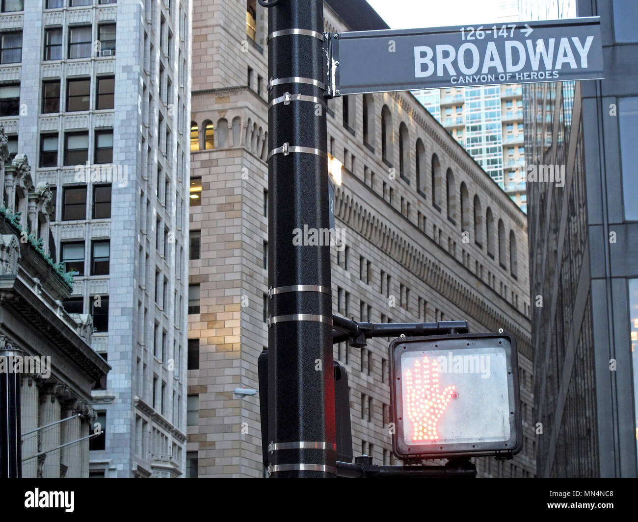 Broadway Street sign, with skyscraper in the background, New York City ...