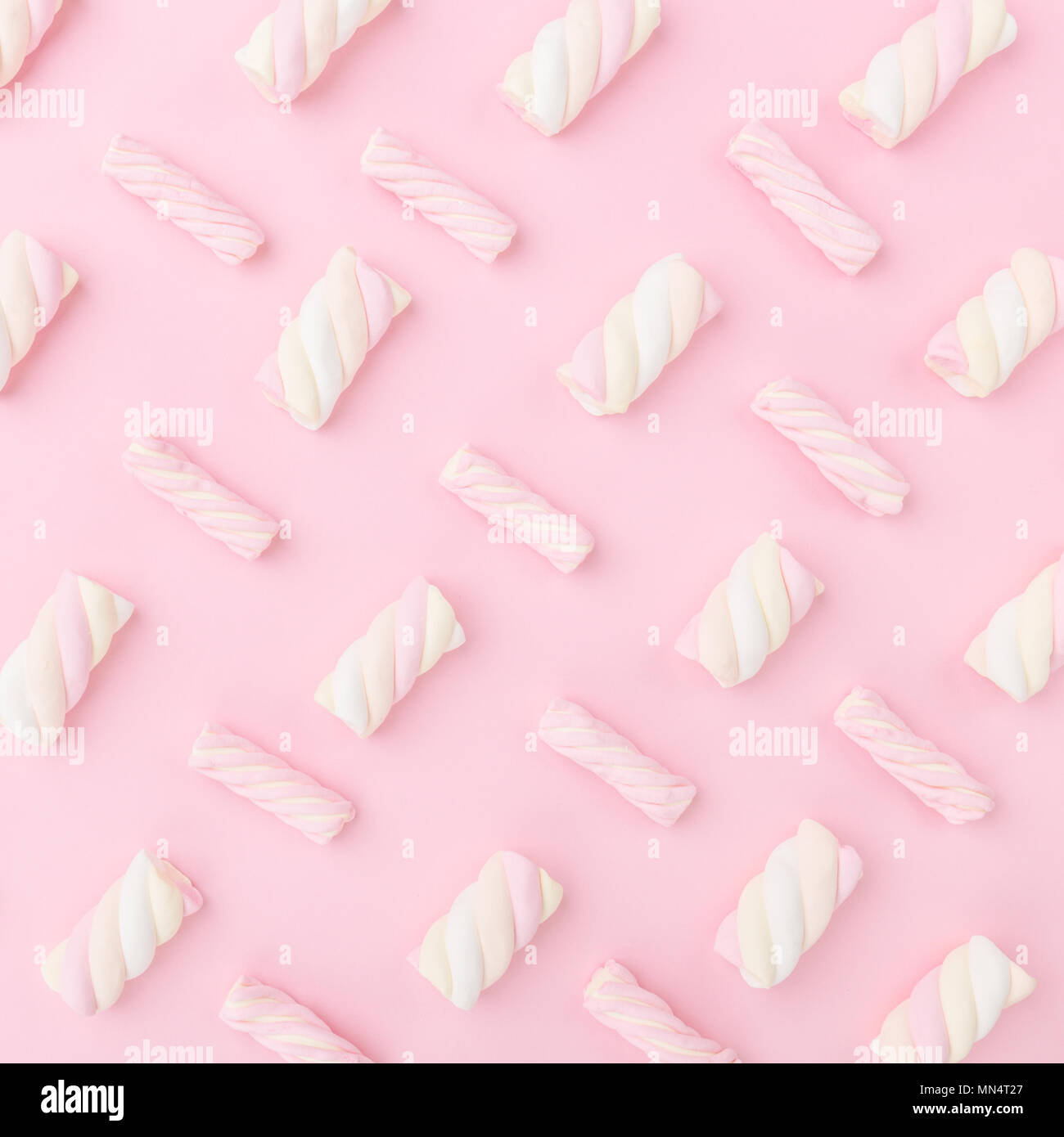 Different pastel color marshmallows on pink pastel background with copy ...