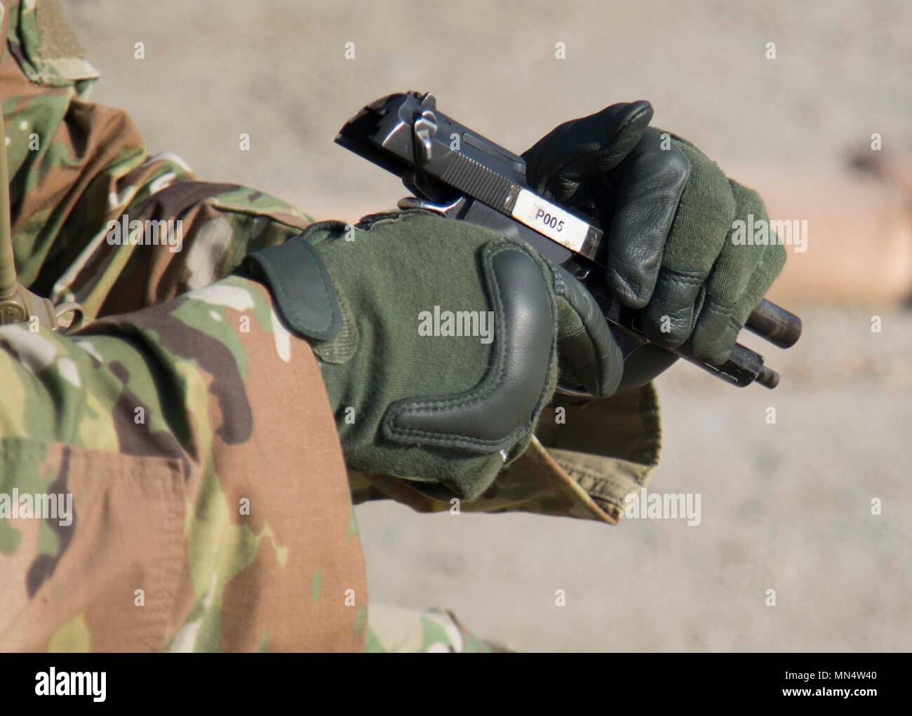 A 3rd Infantry Division Soldier clears his M9 pistol during weapons ...