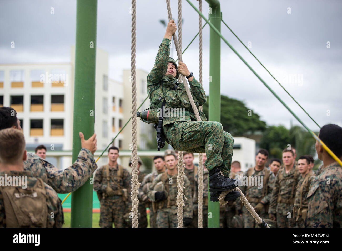 A Singapore Armed Forces Soldier demonstrates how to climb a rope at ...