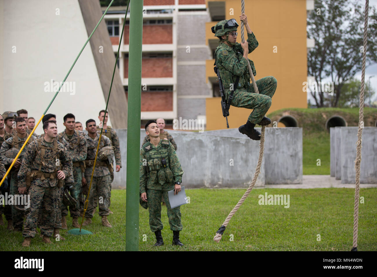 A Singapore Armed Forces Soldier demonstrates how to climb a rope at ...