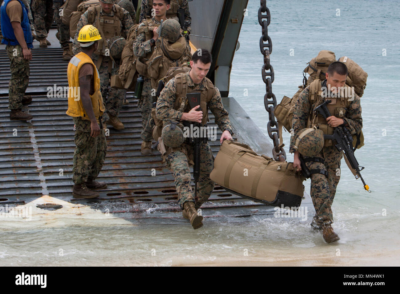 Marines with the 31st Marine Expeditionary Unit step off a landing craft, utility to begin ...