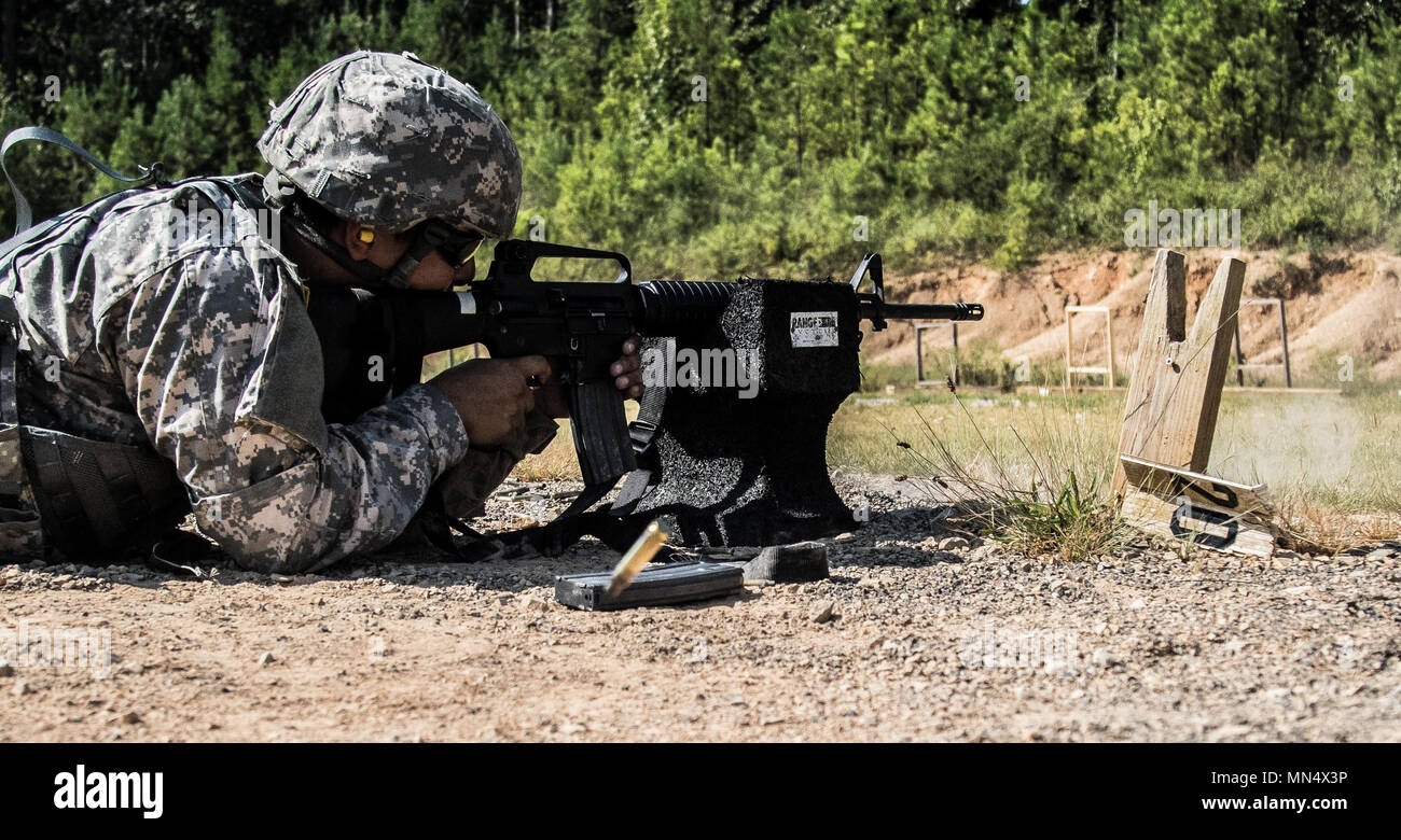 A brass casing flies out of an M16 rifle fired by U.S. Army Spc. Liam J ...