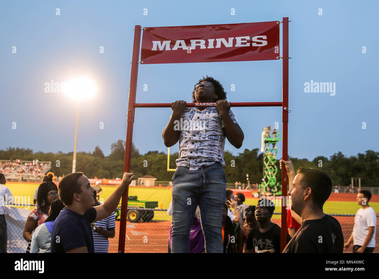 A fan participates in a Marine Corps chin-up challenge during the ...