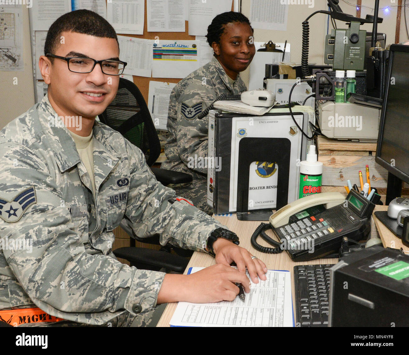U.S. Air Force Senior Airman Johan Pena, foreground, junior controller ...
