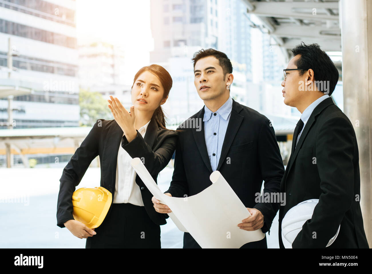 Businesswomen pointing at site for engineering to renovate building ...