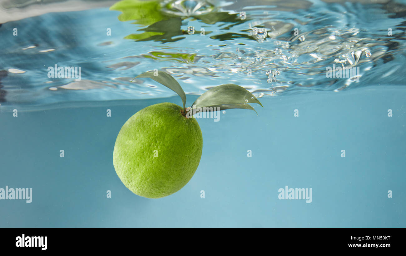 Green lime under water with a trail of transparent bubbles Stock Photo ...