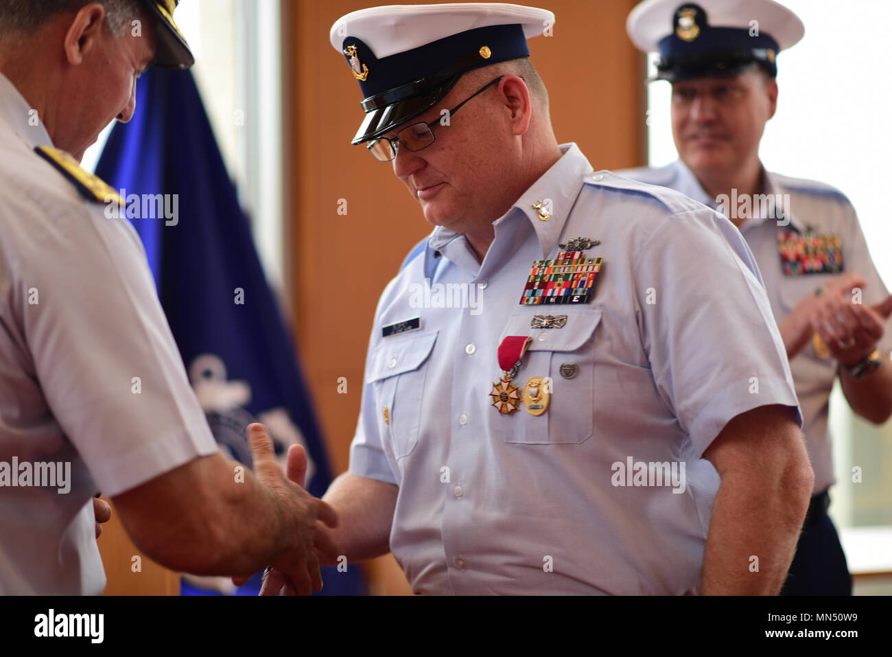 Master Chief Petty Officer Charles “Rob” Bushey is congratulated by ...