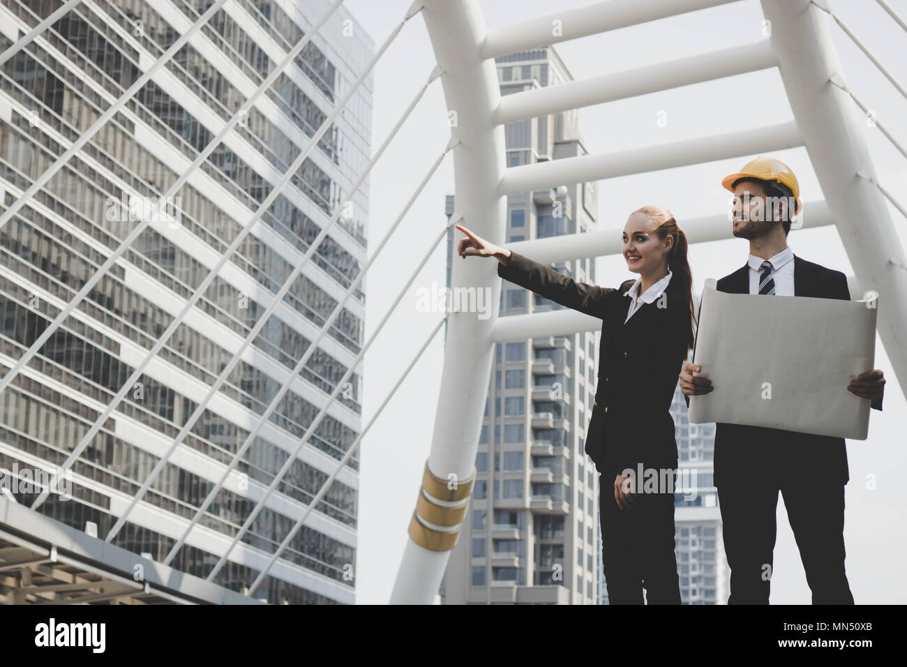 Businesswoman pointing and engineering planning at construction area on ...