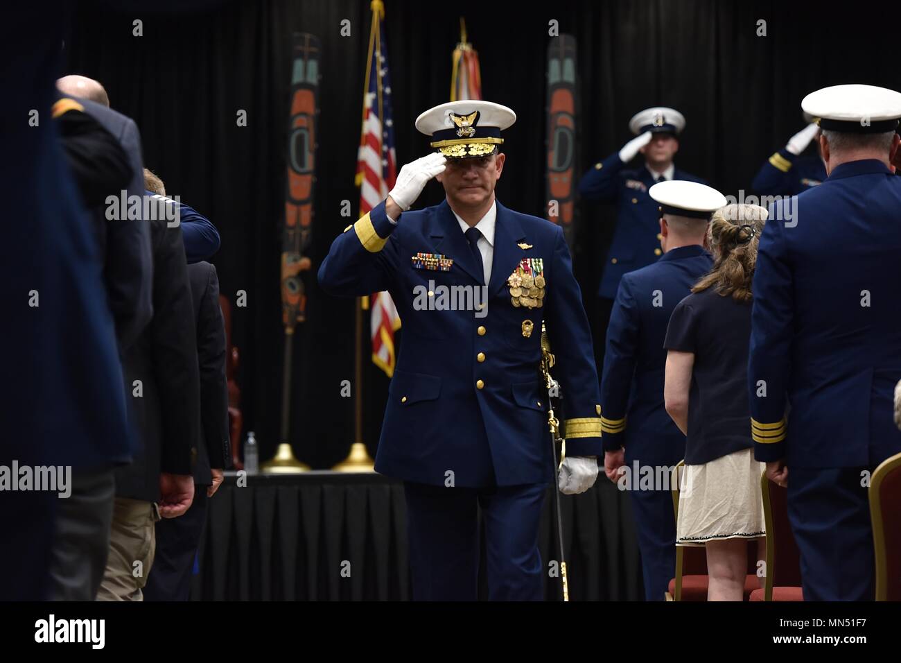 Rear Adm. Matthew T. Bell Jr., is saluted as he departs the change of ...