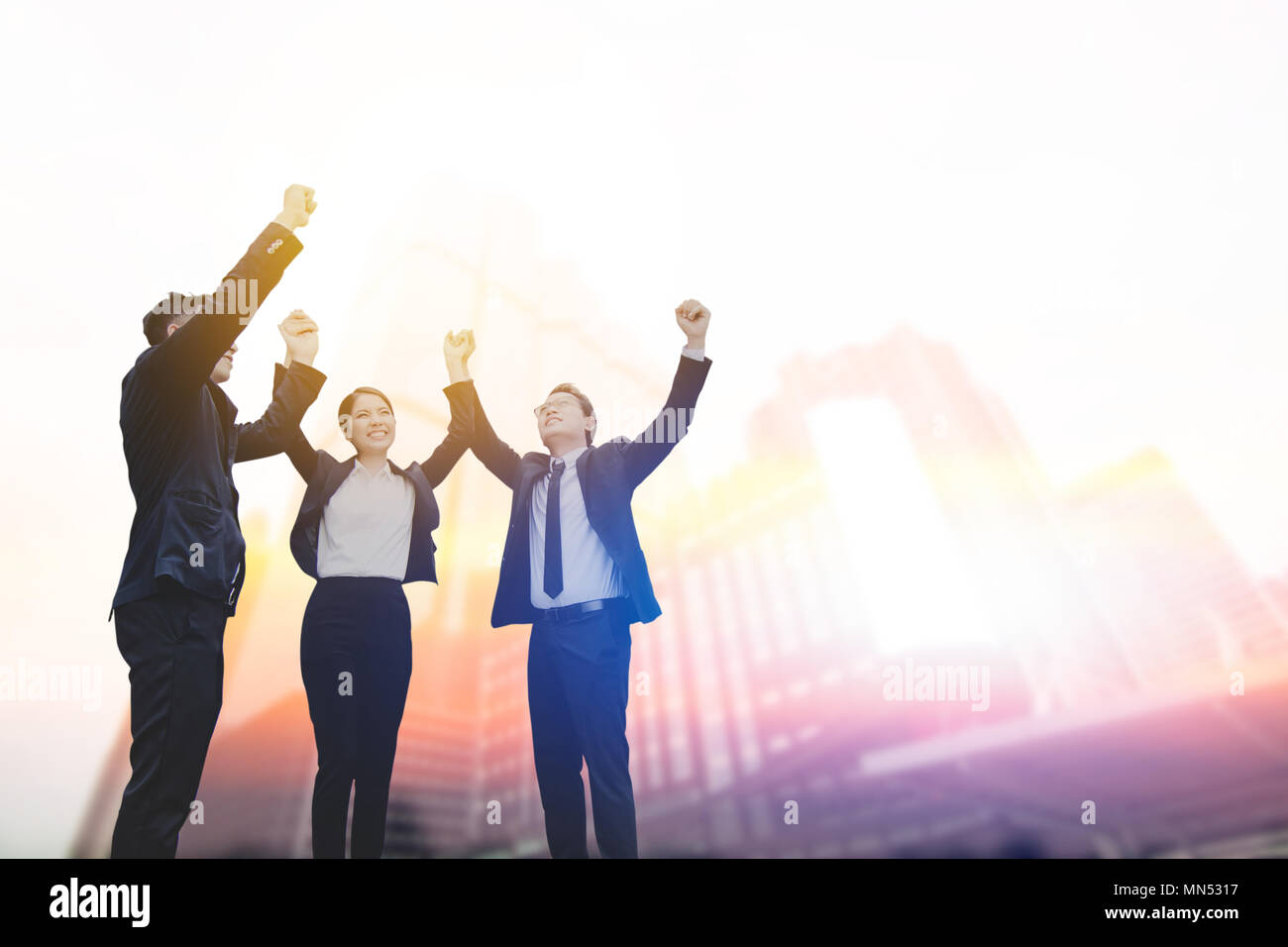 Hand coordination of team businessman on sky infront of bank building ...