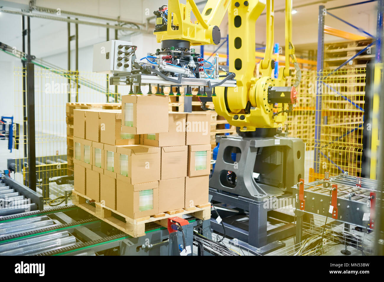 Automatic packaging machine working upon pile of cardboard boxes ...