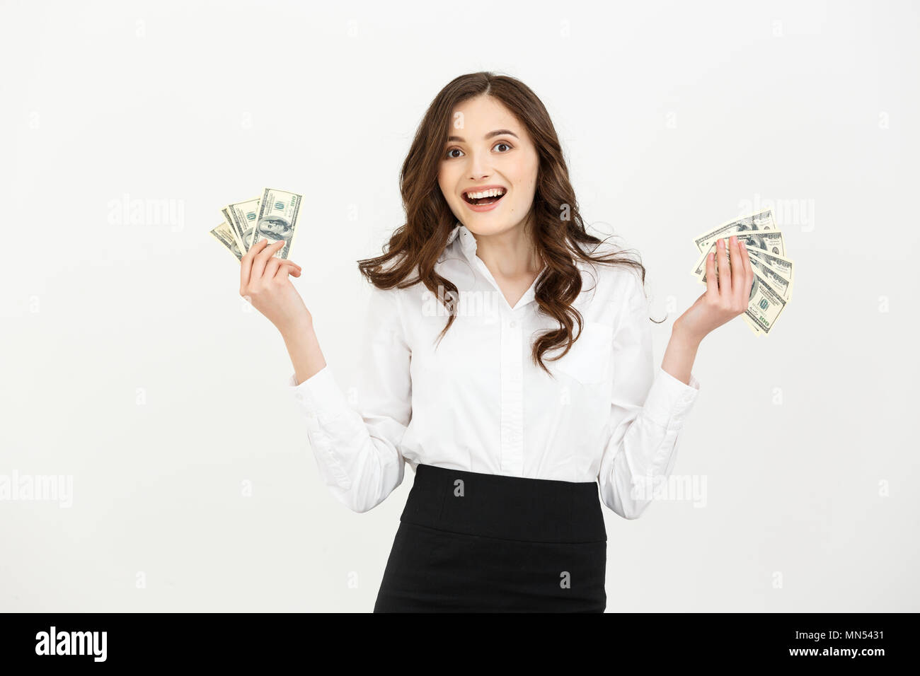 Portrait of a cheerful young business woman holding money banknotes and ...