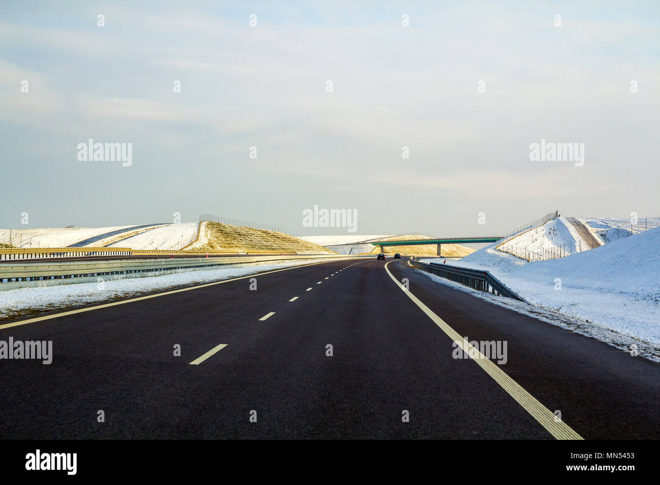 Modern wide smooth empty asphalt highway stretching to horizon under ...