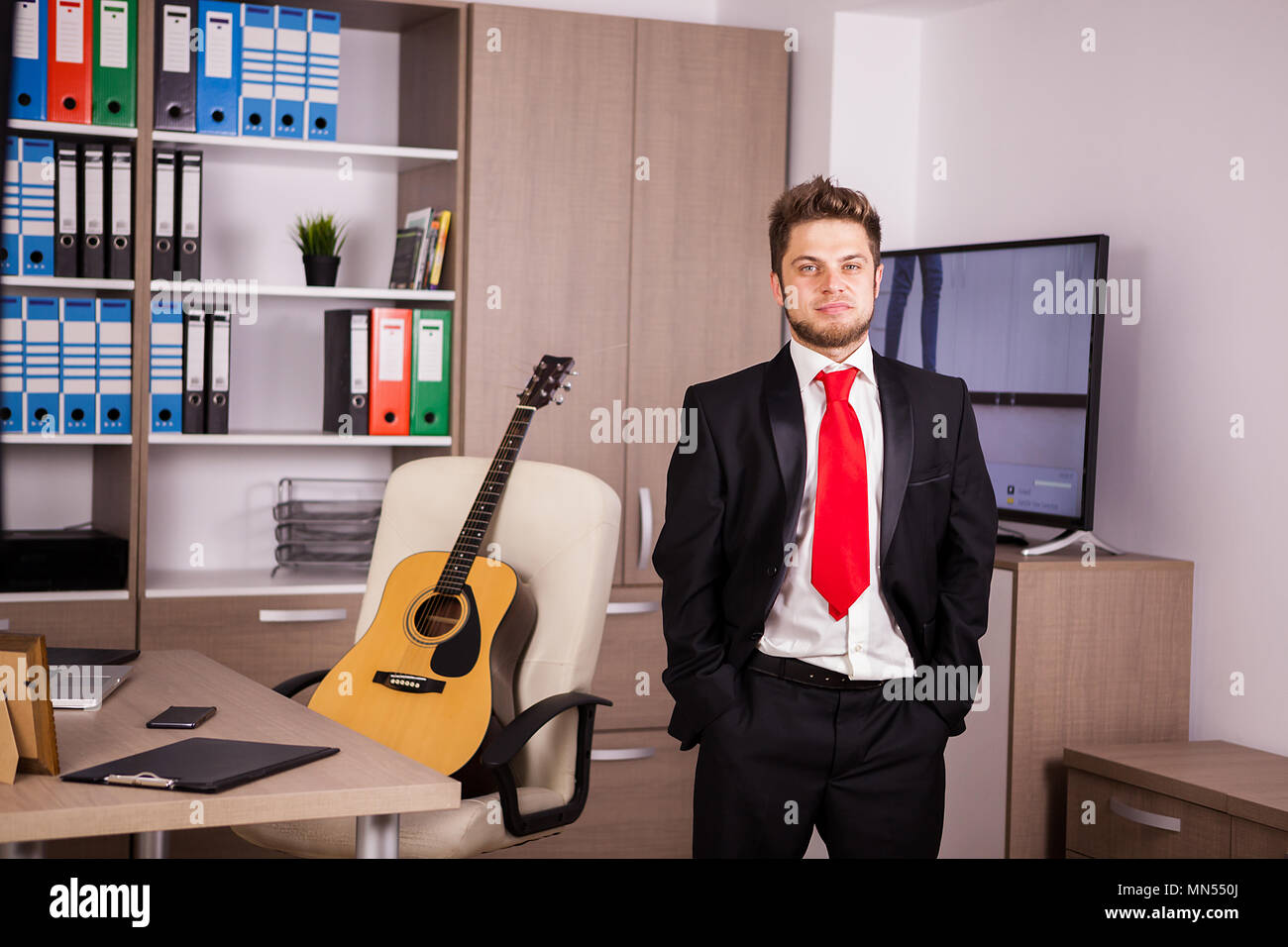 Businessman in formal wear wearing a red tie Stock Photo - Alamy