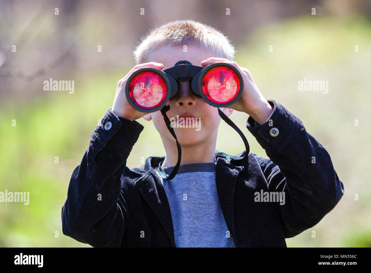 Portrait of little cute handsome cute blond boy watching intently ...