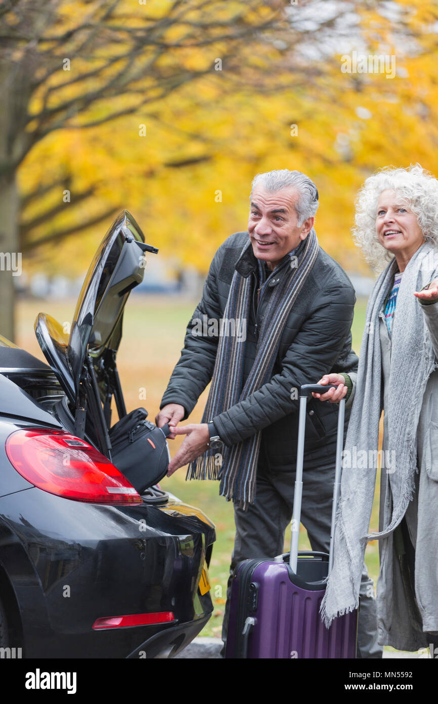 Senior couple removing luggage from car trunk Stock Photo - Alamy
