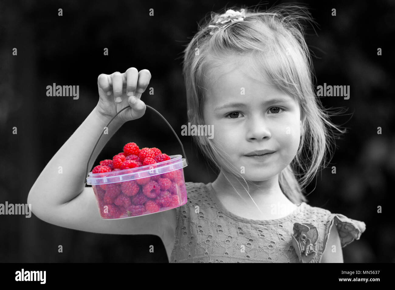 Black and white portrait of a little girl child holdind small basket of ...