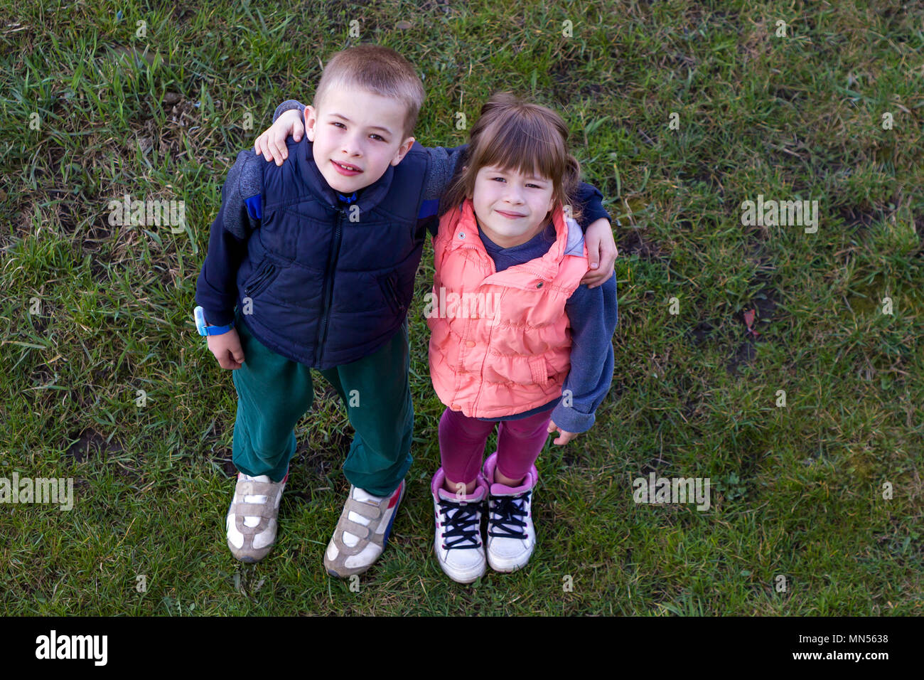 View from above of two cute children in casual clothes boy and girl ...