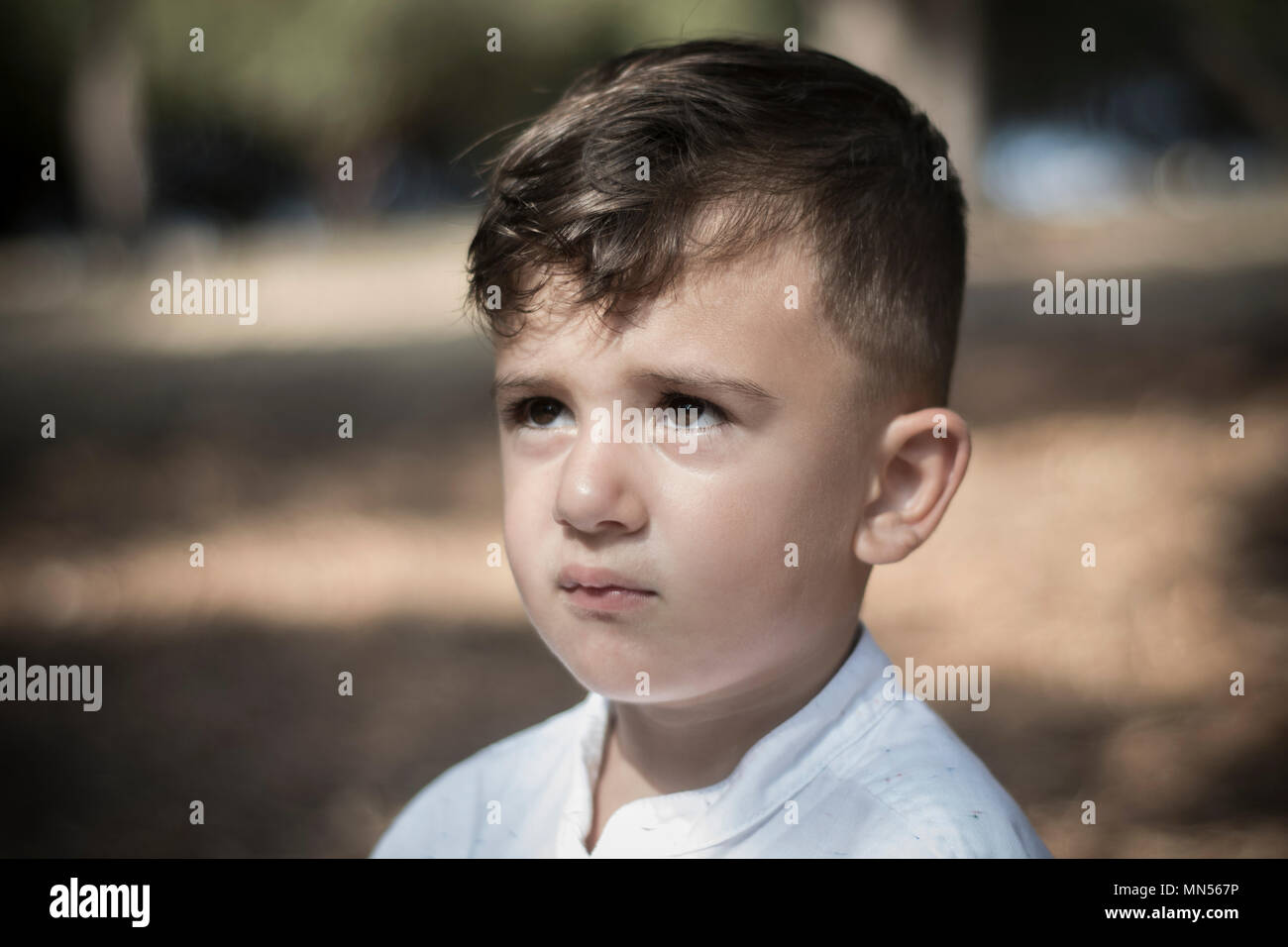 Sad boy looking up outdoors Stock Photo - Alamy