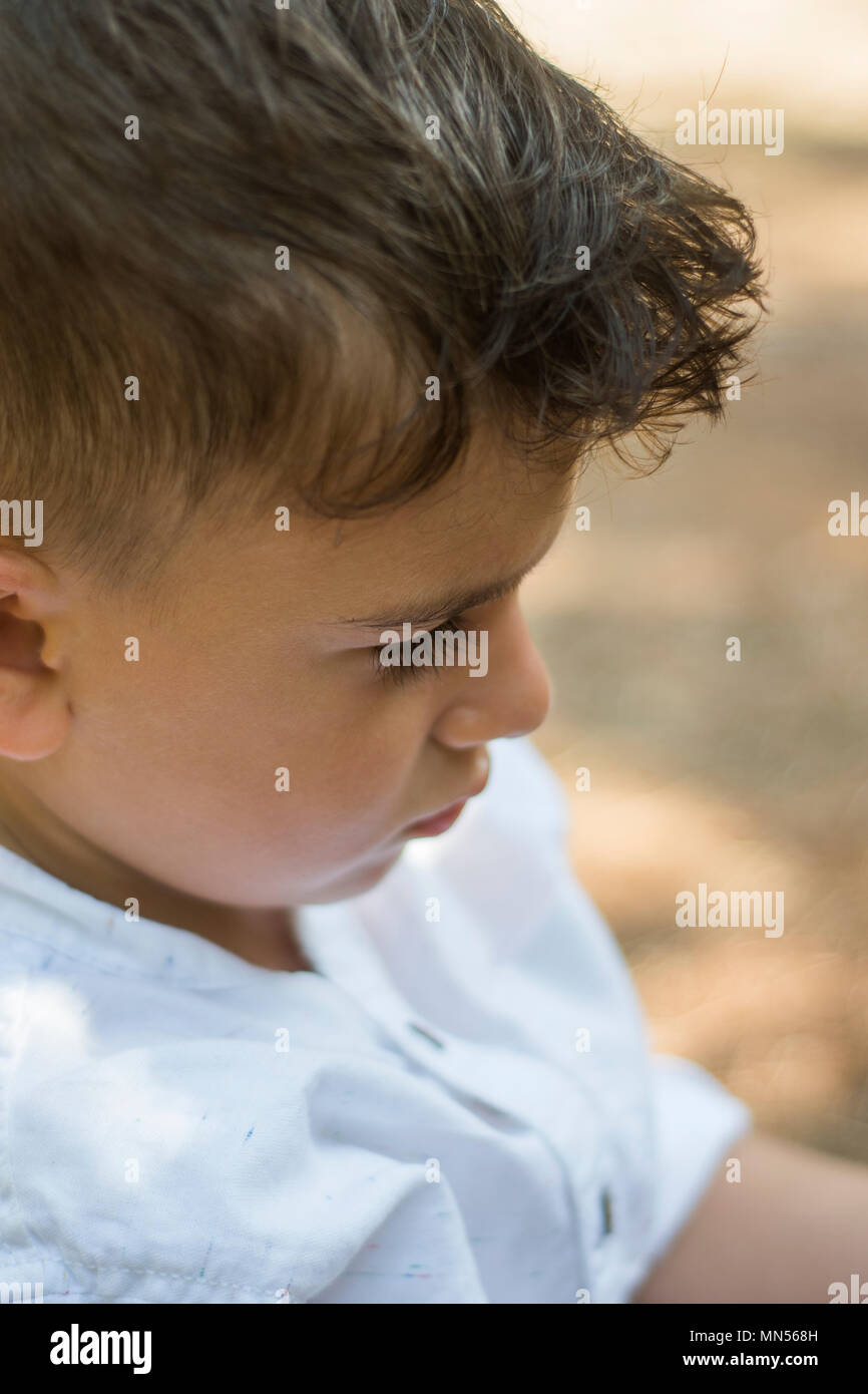 Side view of a sad little boy Stock Photo - Alamy