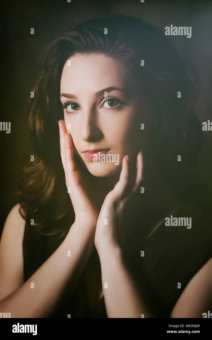 Beautiful young woman hands touching face Stock Photo - Alamy