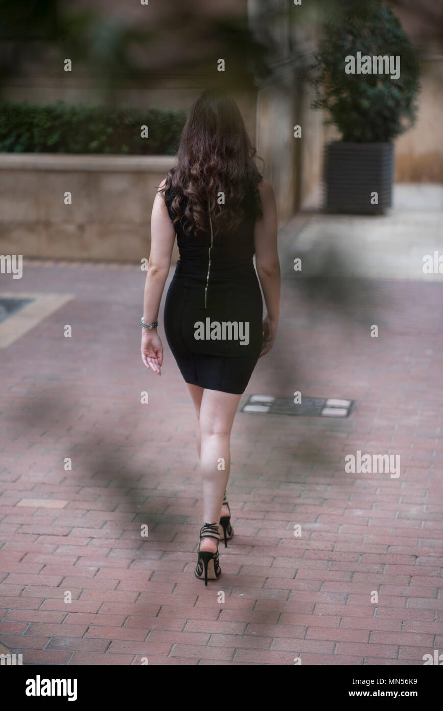 Woman walking away rear dress hi-res stock photography and images - Alamy