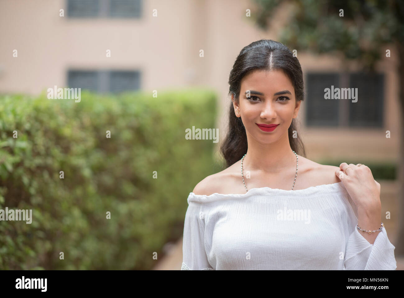 Beautiful young woman hand touching shoulder smiling outdoors Stock ...