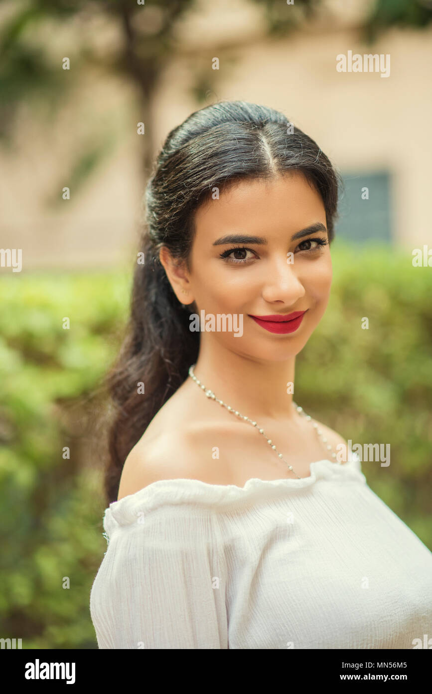 Beautiful young woman smiling outdoors Stock Photo - Alamy