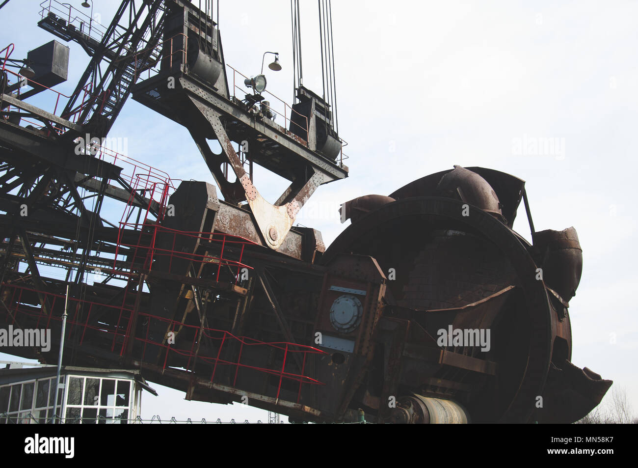 The huge coal mining machine captured with focus on mining wheel and ...
