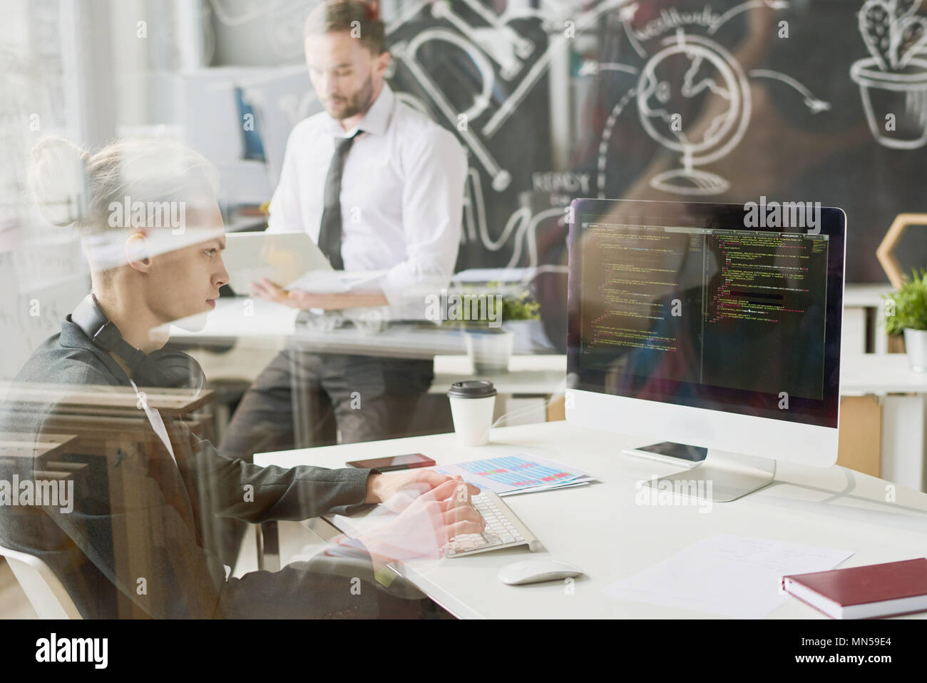 Side view portrait of contemporary young man coding using computer ...