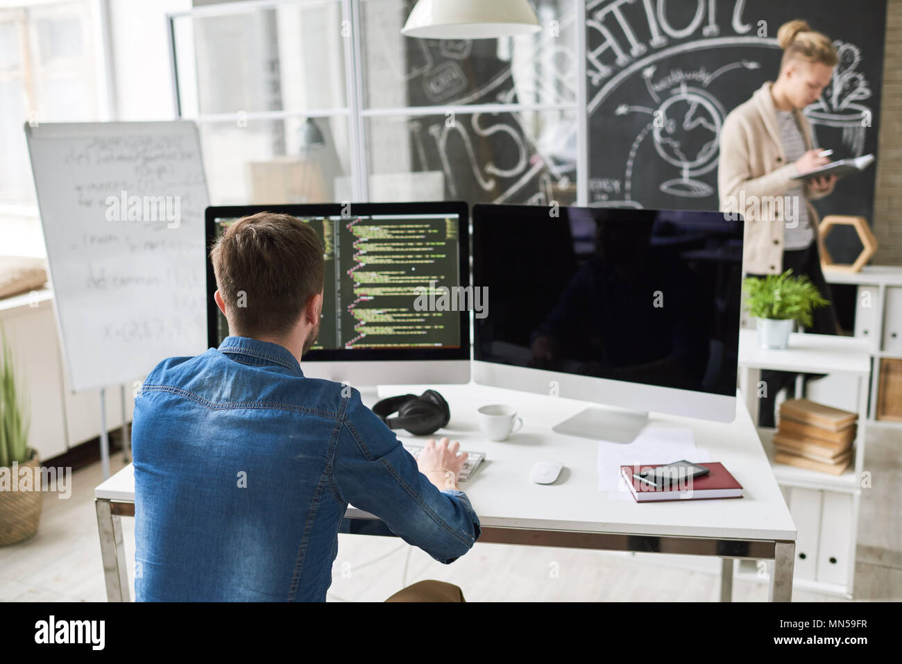 Back view portrait of contemporary program developer writing code ...