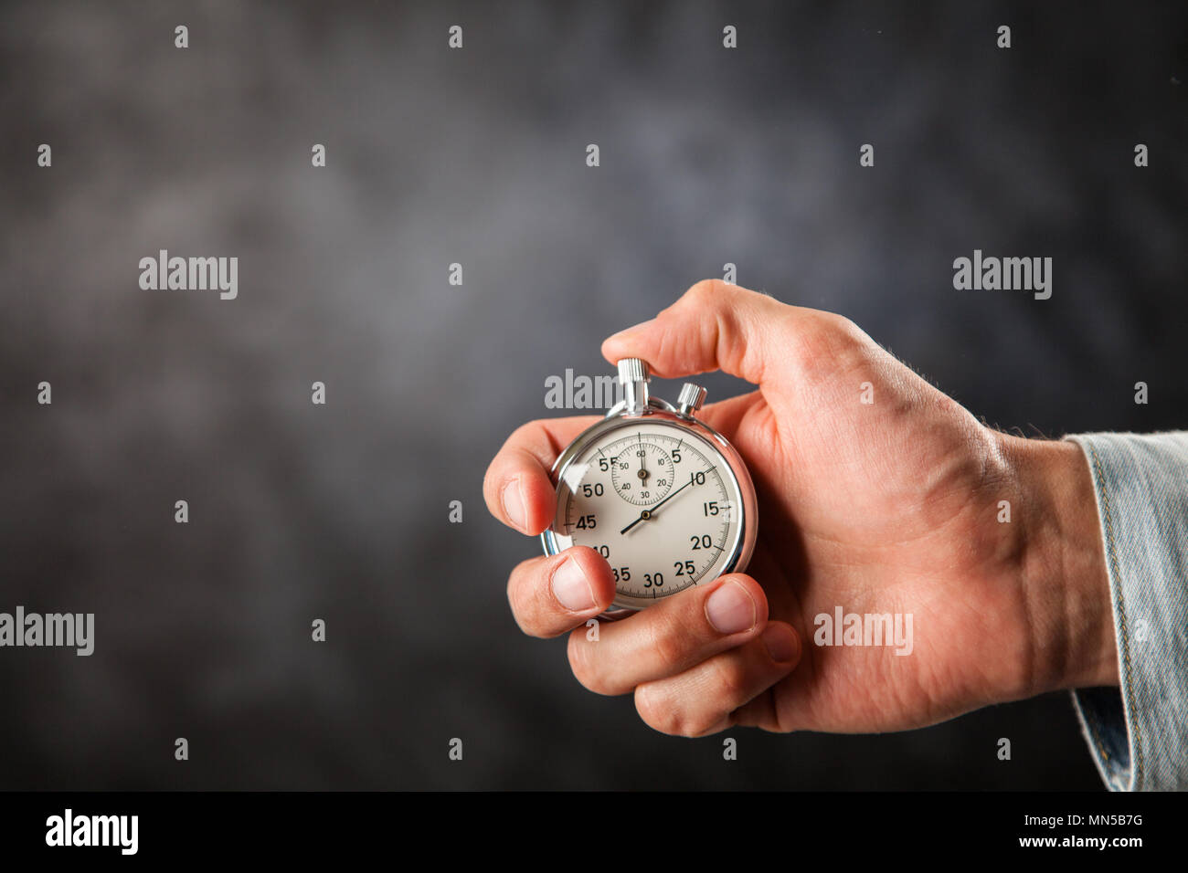 Analog stopwatch closeup on black background Stock Photo - Alamy