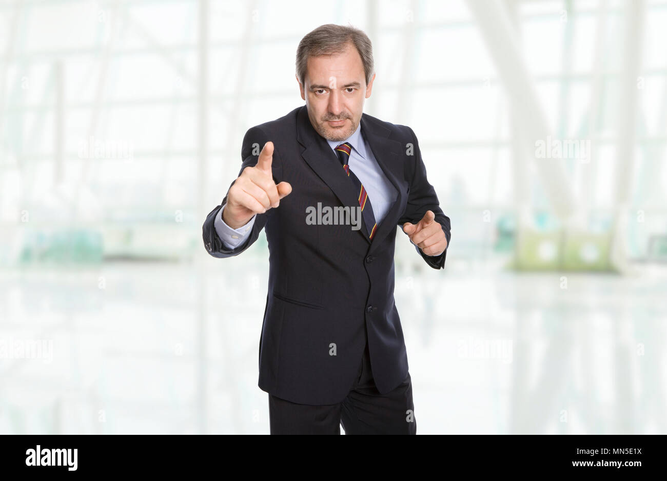 mature business man pointing, at the office Stock Photo - Alamy