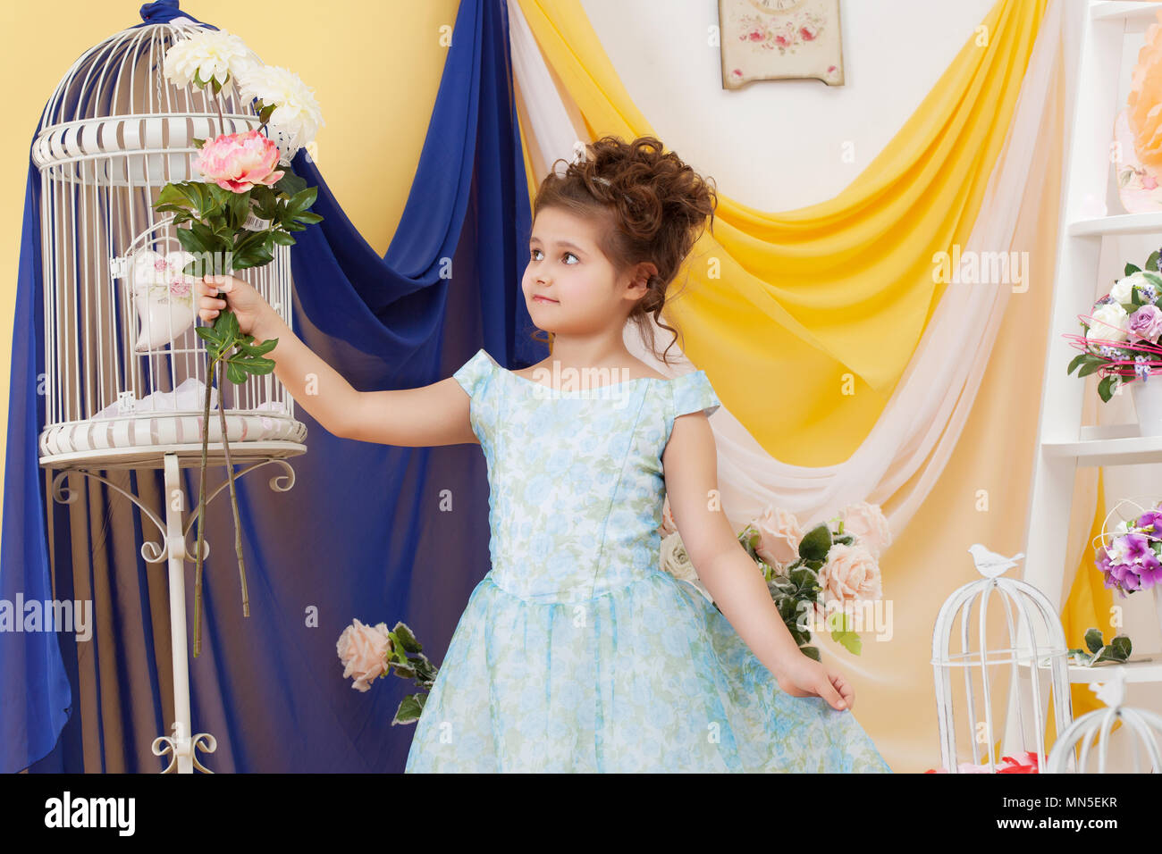 Smart smiling girl posing in decorated studio Stock Photo - Alamy