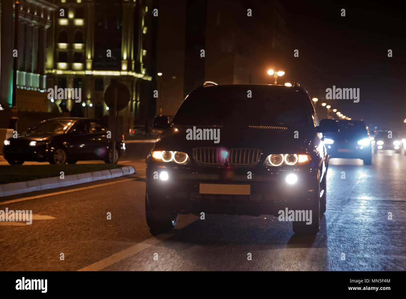 Road in the city at the night with yellow and red electrical light for ...