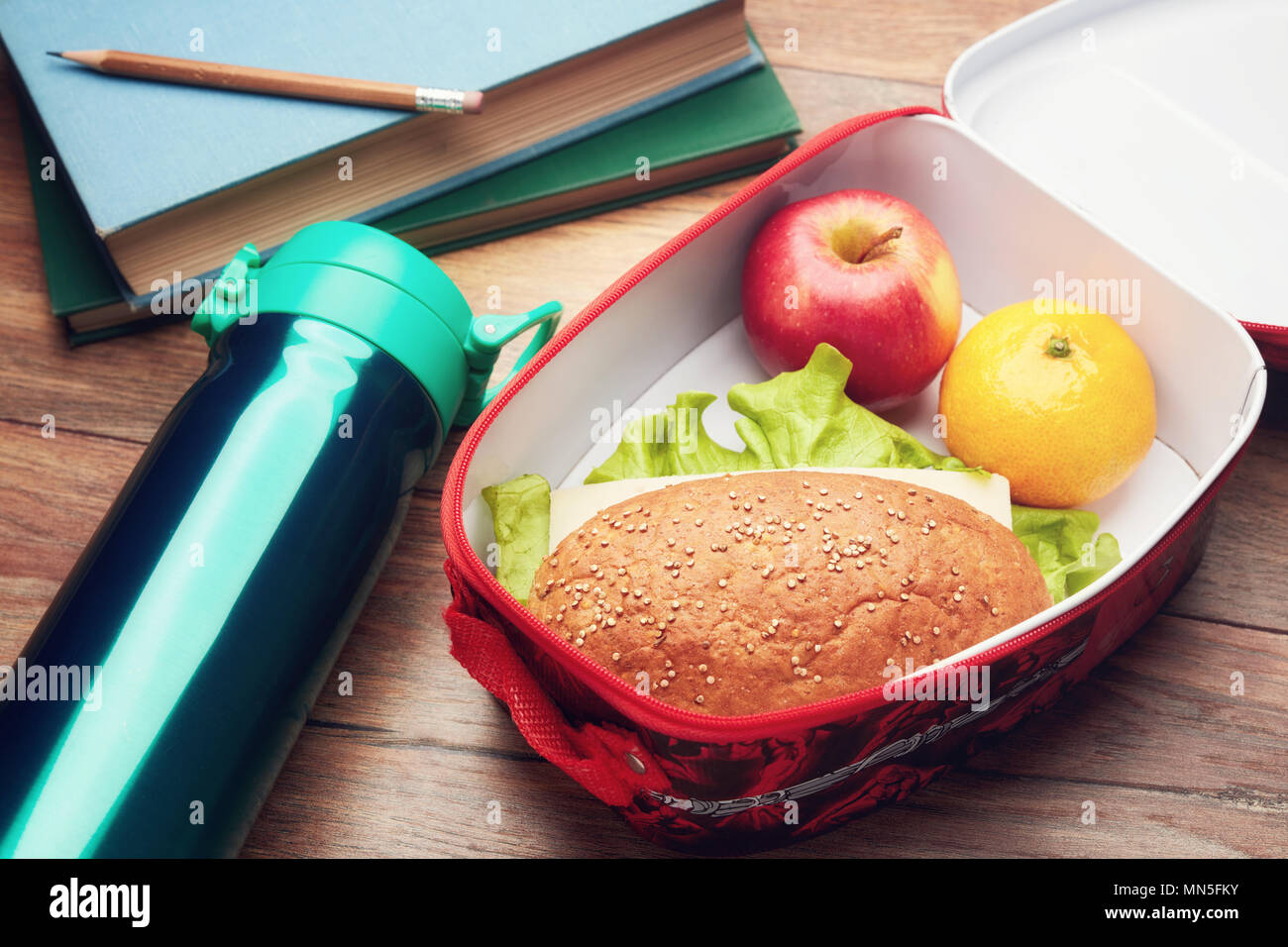 Healthy lunch box with whole wheat bread sandwich, fresh fruits, and ...